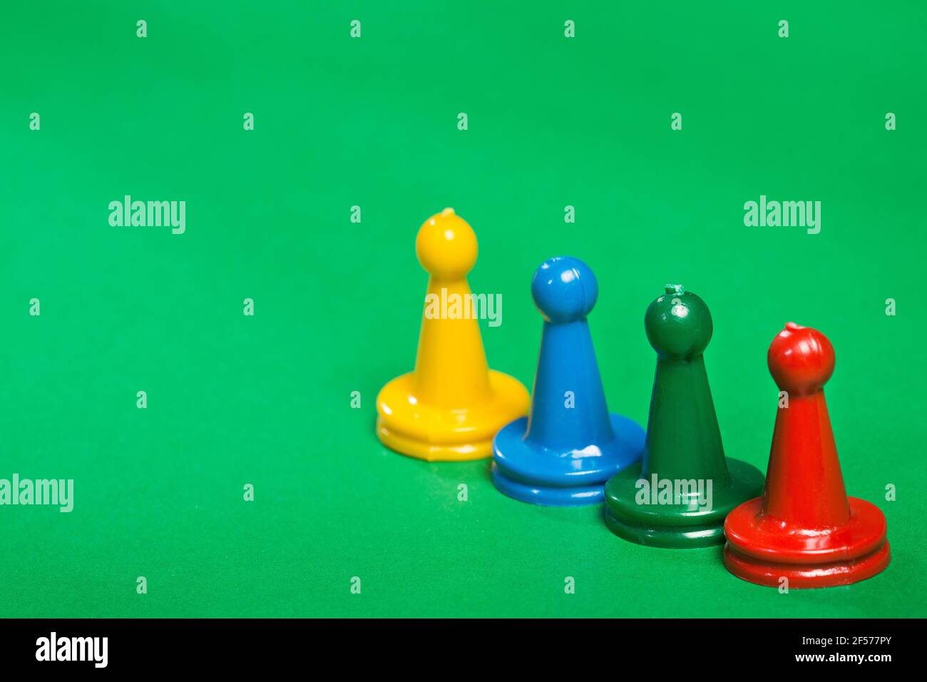 Many colorful game pieces, plastic figures Stock Photo - Alamy