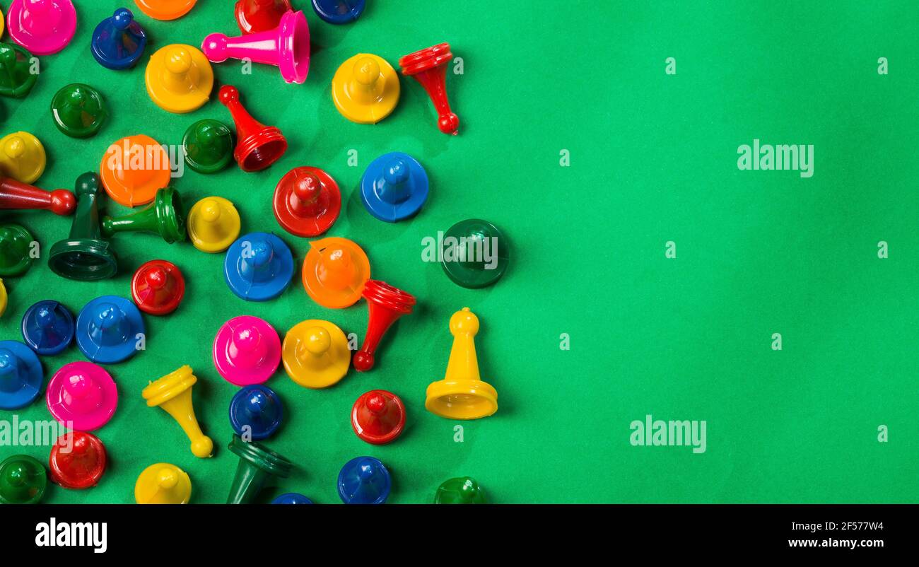 Many colorful game pieces, plastic figures Stock Photo - Alamy