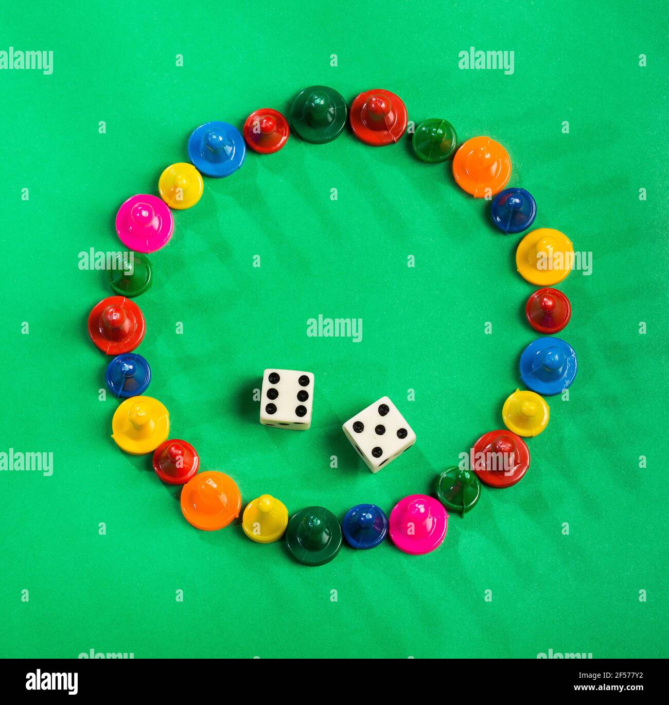Colorful game pieces and dice Stock Photo - Alamy