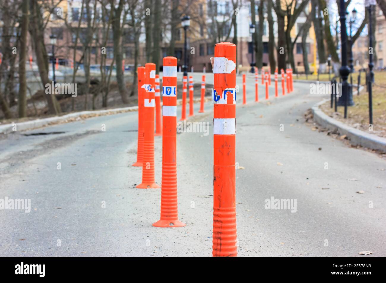 A line of flexible safety PVC delineators, orange plastic road poles ...