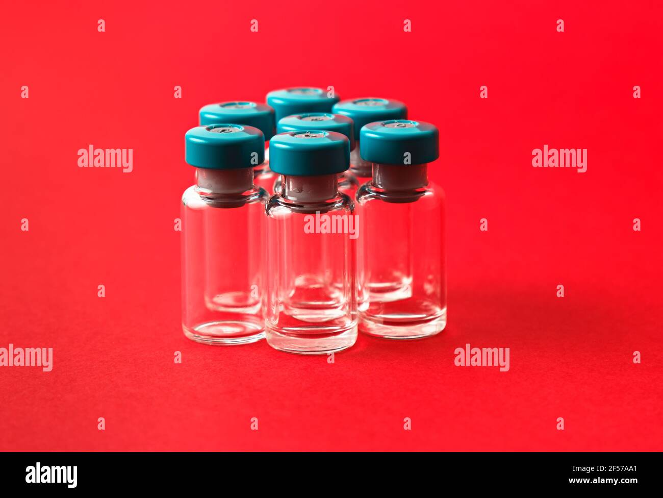 Several empty medical vials on red background Stock Photo - Alamy