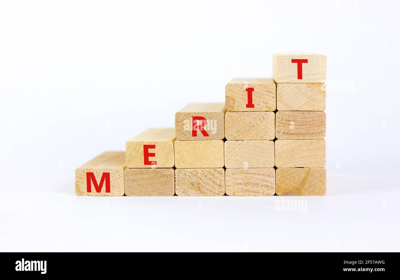 Merit symbol. Wooden blocks with the word 'merit'. Beautiful white ...