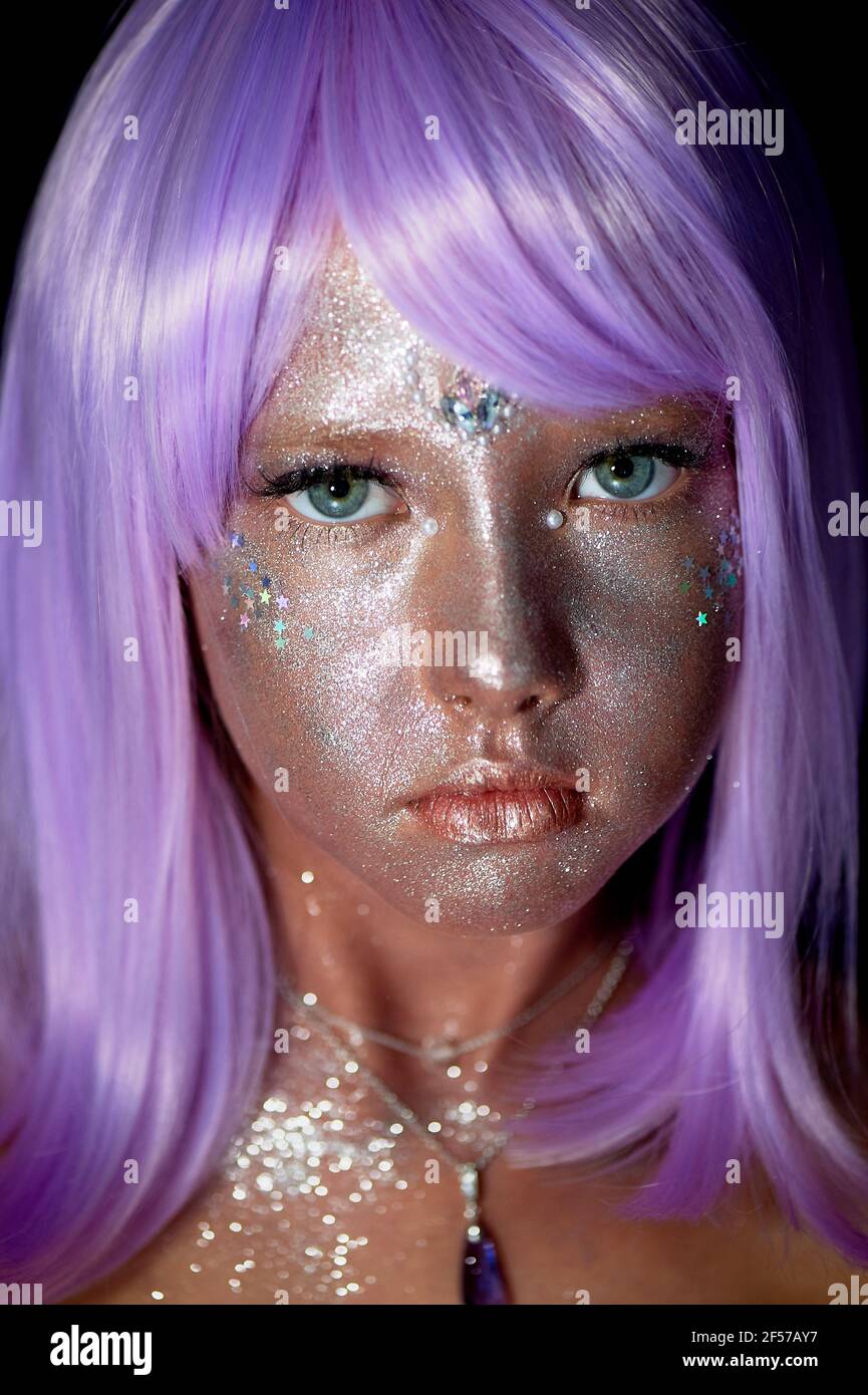 A girl with purple hair and glowing skin. An alien or a fairy with ...