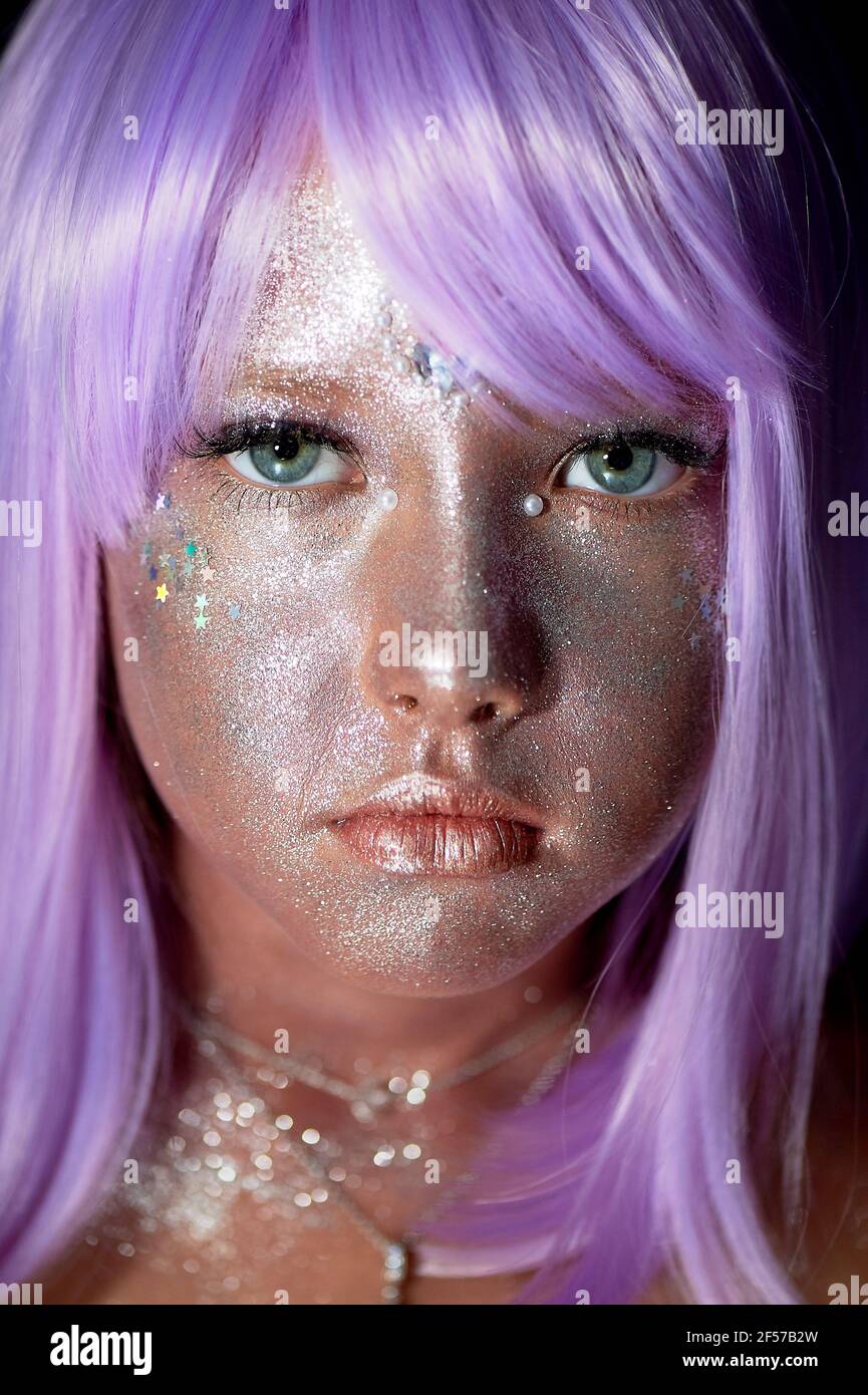 A girl with purple hair and glowing skin. An alien or a fairy with ...