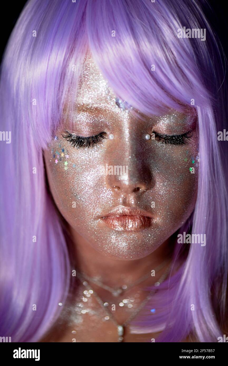 A girl with purple hair and glowing skin. An alien or a fairy with ...