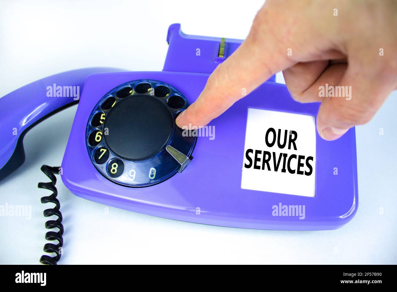 Our services symbol. Old blue rotary dial telephone. Words 'our ...
