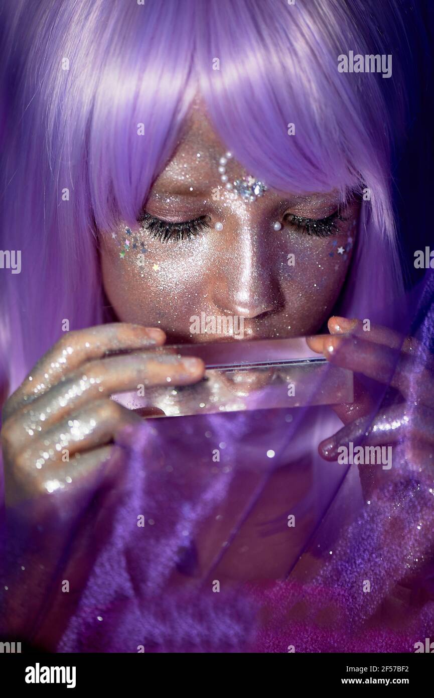 A girl with purple hair and glowing skin. An alien or a fairy with ...