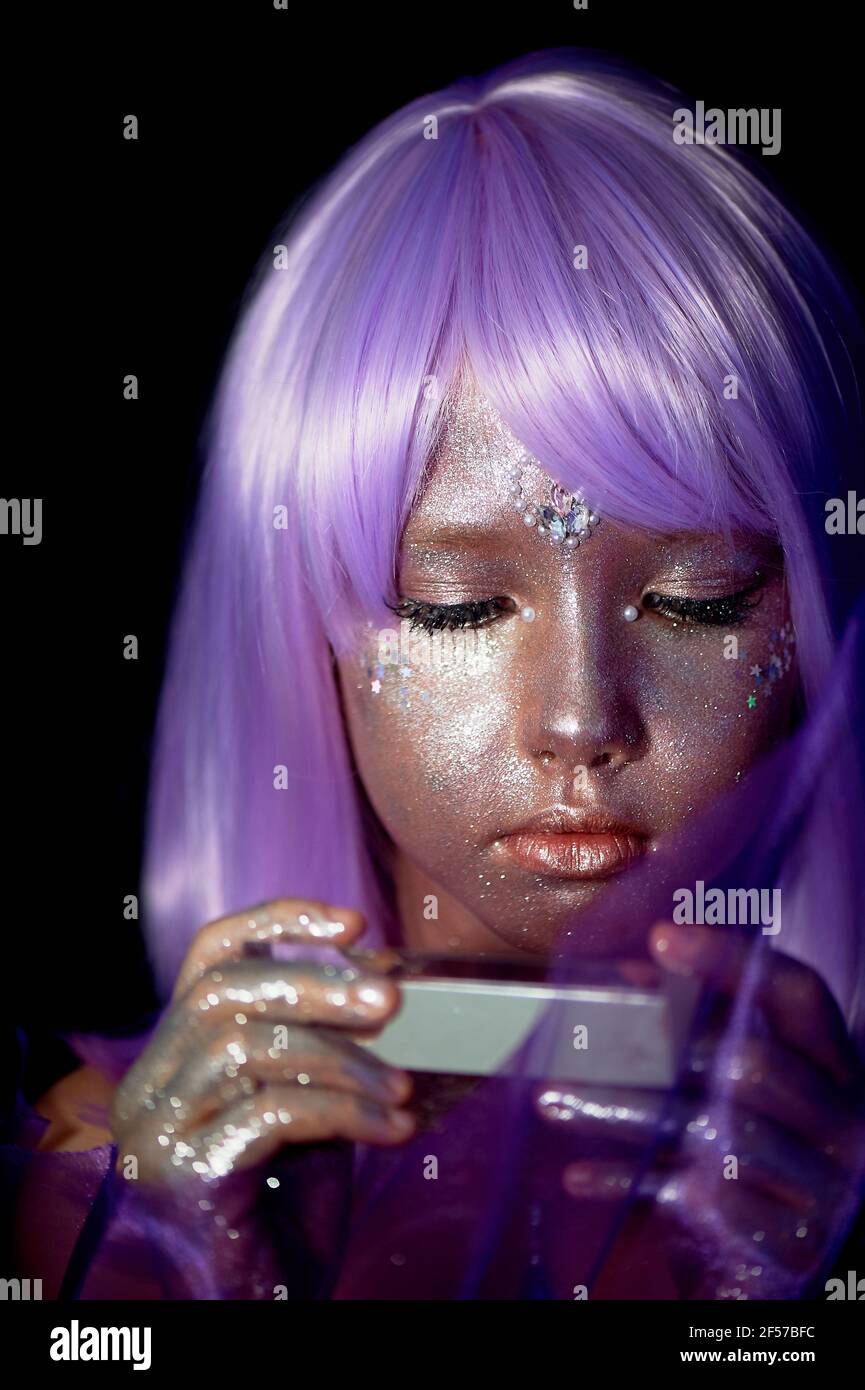 A girl with purple hair and glowing skin. An alien or a fairy with ...