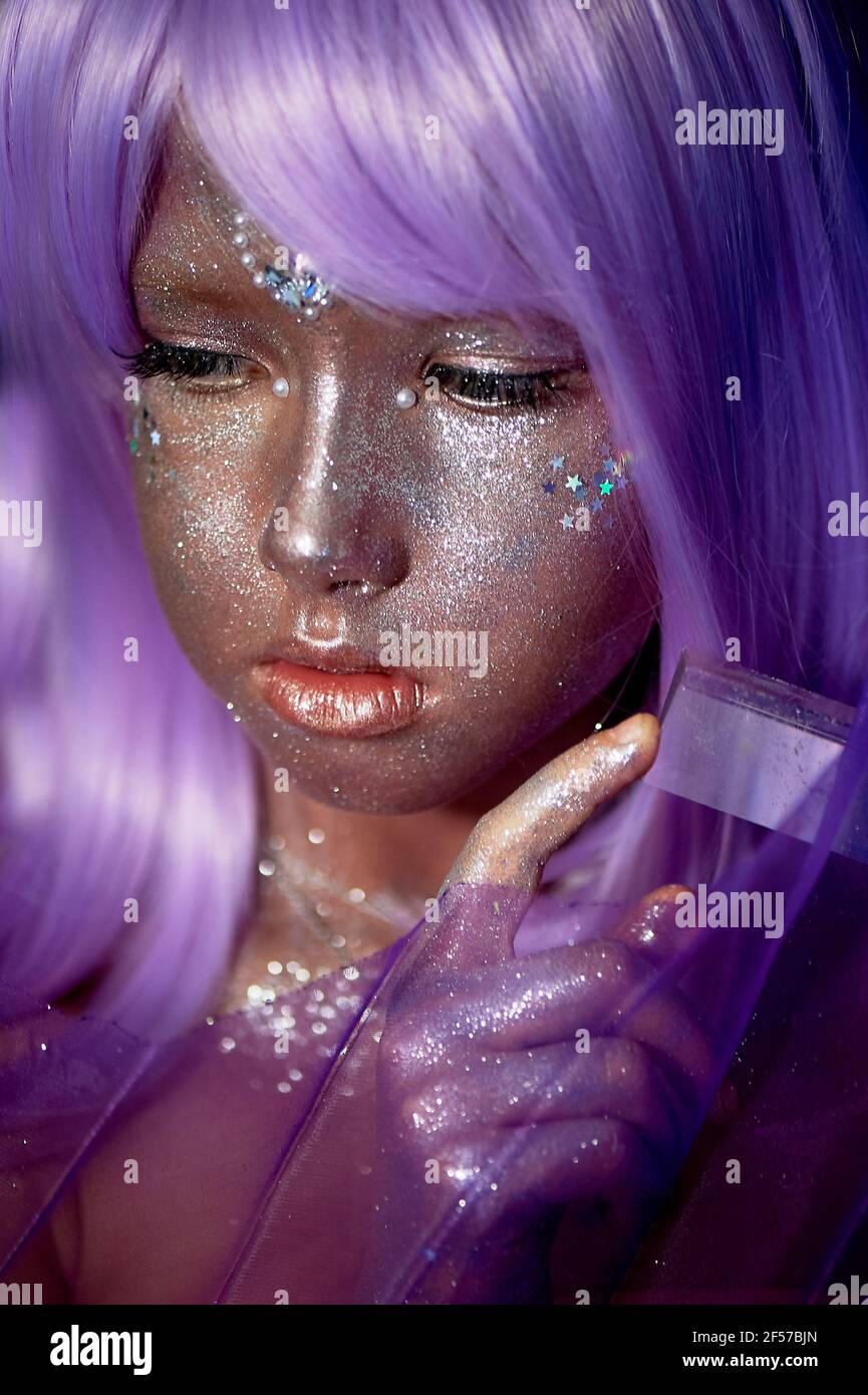 A girl with purple hair and glowing skin. An alien or a fairy with ...