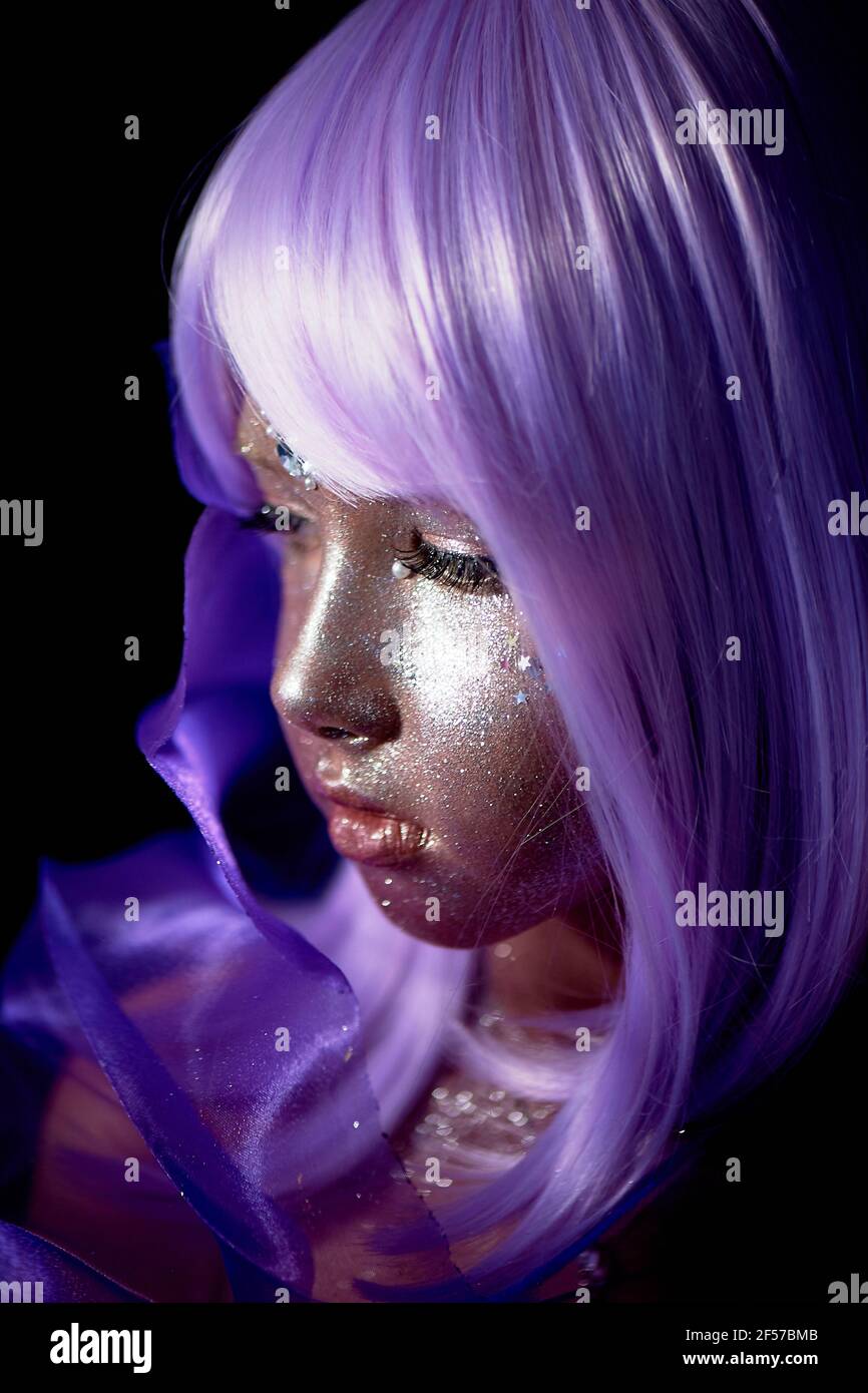 A girl with purple hair and glowing skin. An alien or a fairy with ...