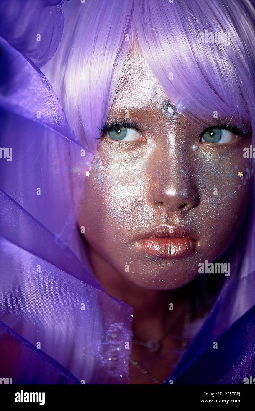 A girl with purple hair and glowing skin. An alien or a fairy with ...