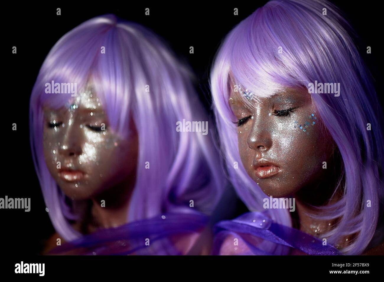 A girl with purple hair and glowing skin. An alien or a fairy with ...