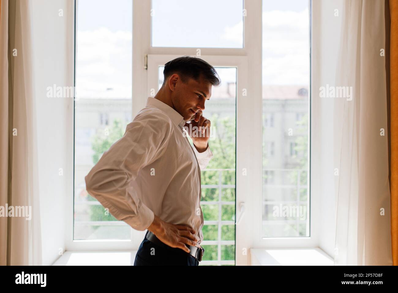 Relaxed young man resting from work. Man enjoy break stretching in home ...