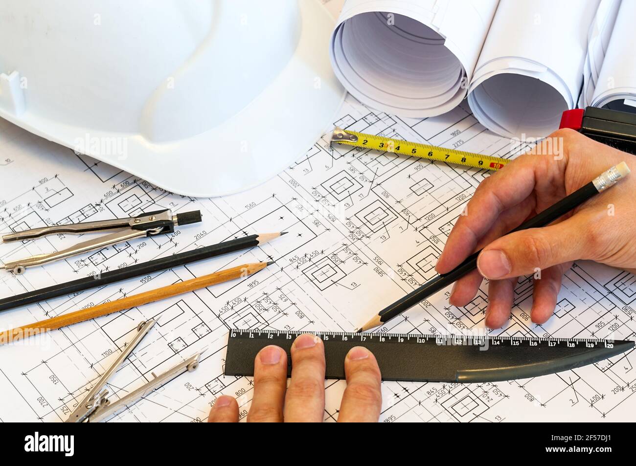 Close-up view at human hands drawing with pencil and ruller on ...