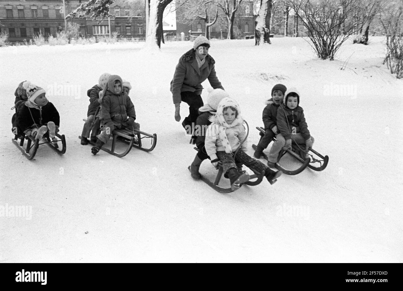 Children ride sledges Black and White Stock Photos & Images - Alamy