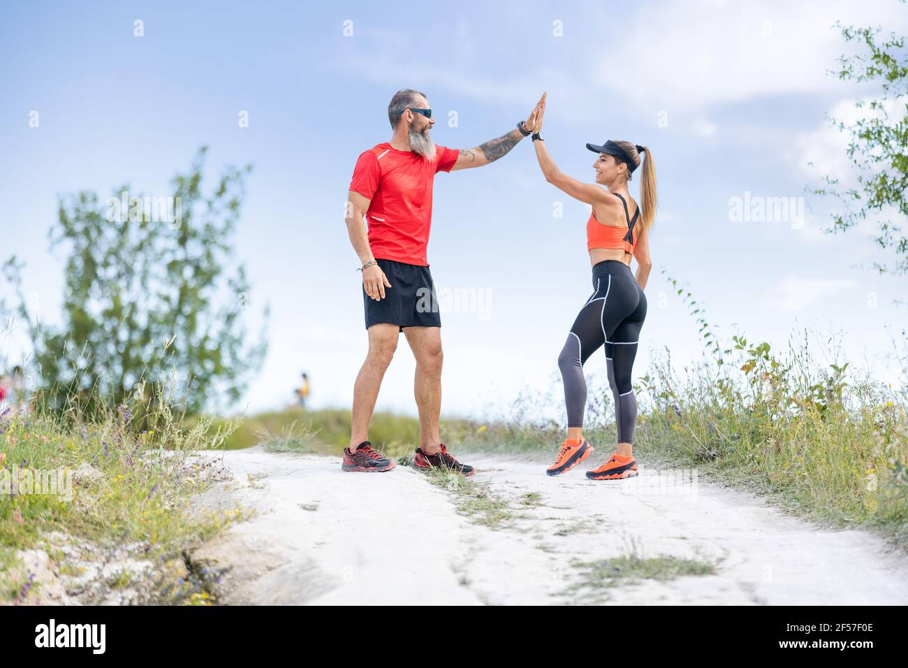 Running high five hi-res stock photography and images - Alamy
