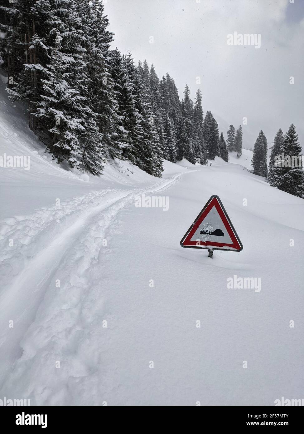 Heavy snowfall causes warning signs to sink into the pass road. Ski ...