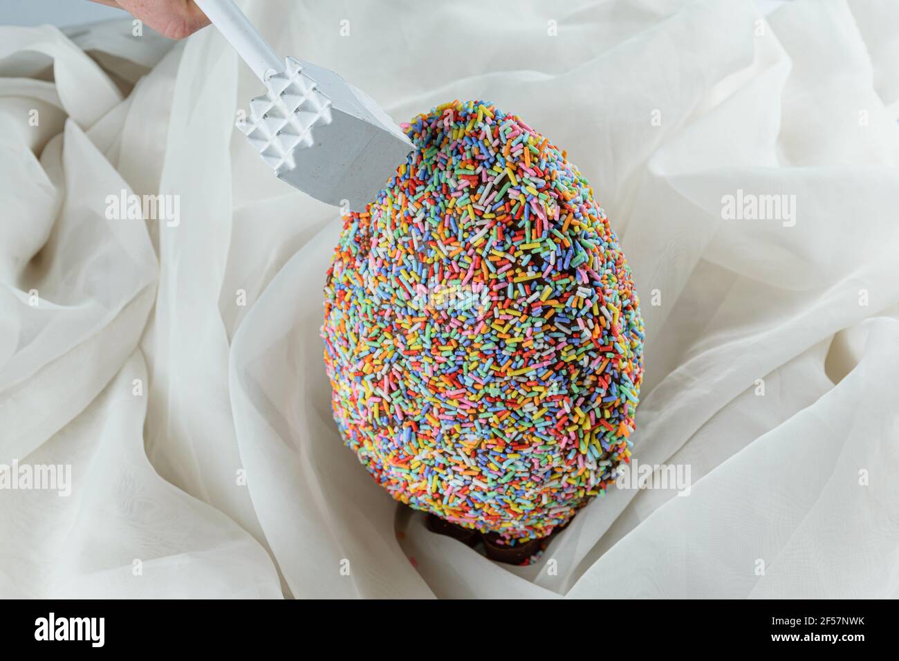 Woman's hand with a hammer prepared to break the Easter egg (pinata ...