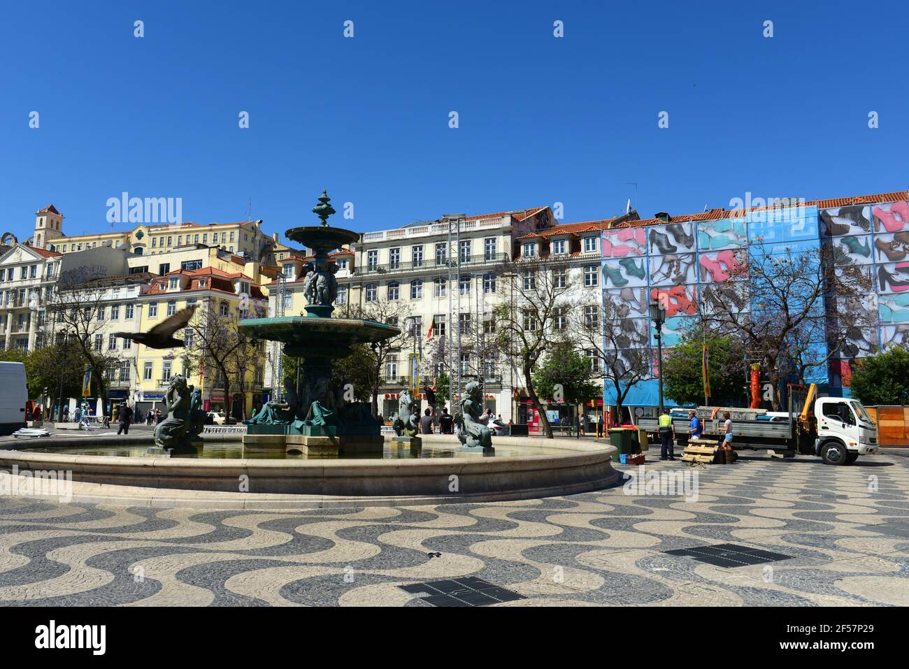 Historic buildings and Bronze Fountain at Rossio Square in downtown ...