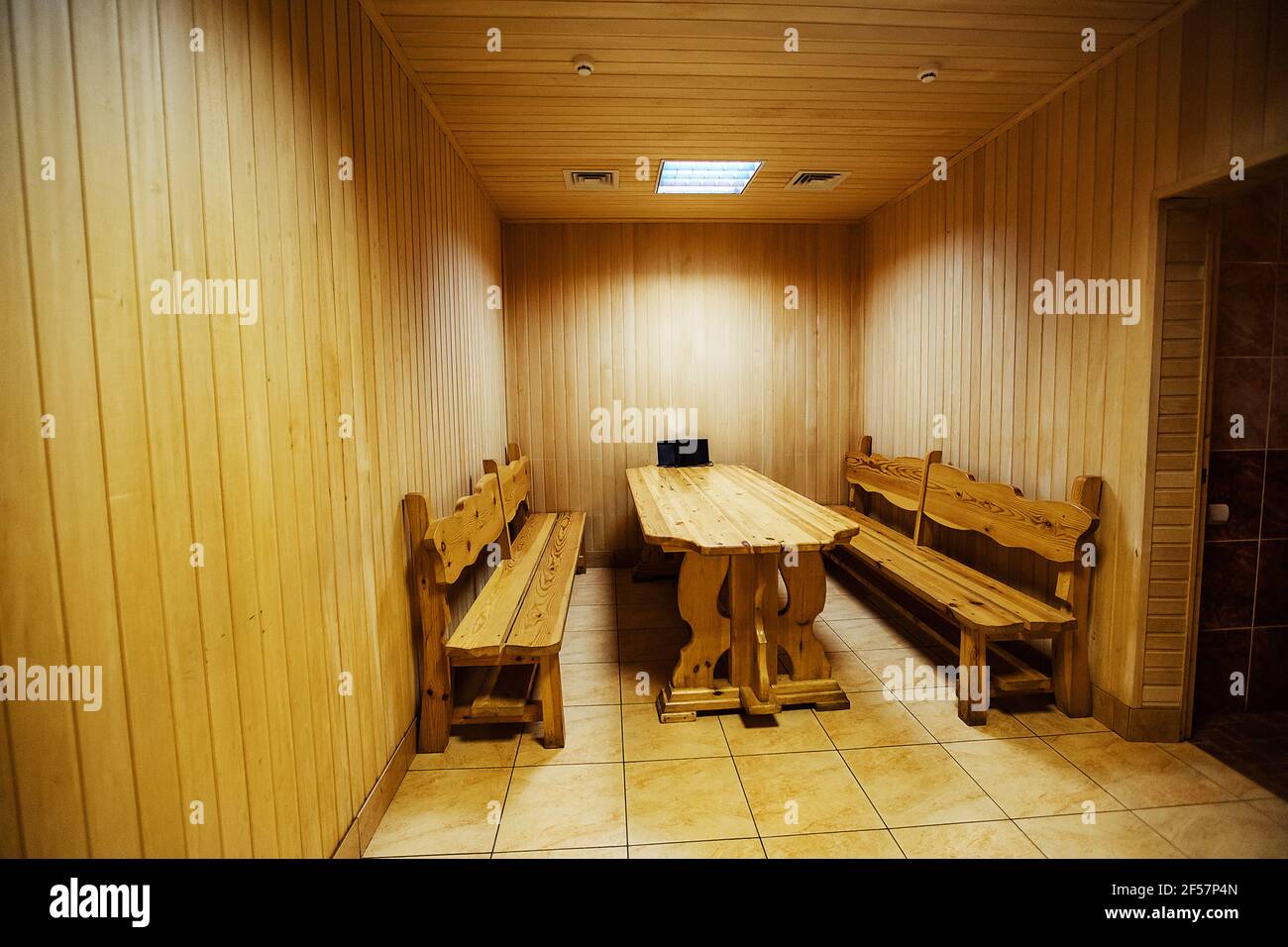 wooden table and chairs in the sauna. dressing room and steam room for ...