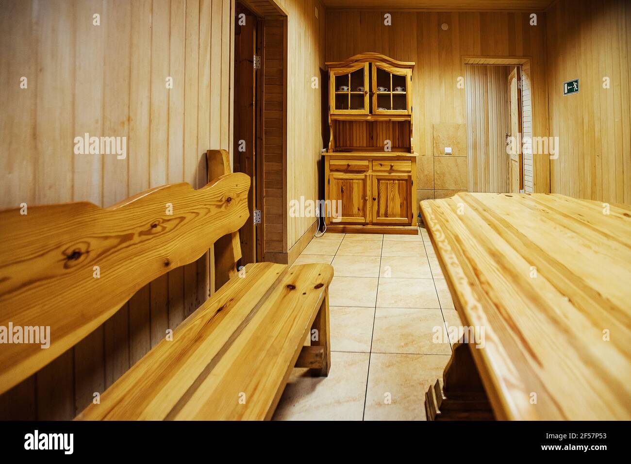 wooden table and chairs in the sauna. dressing room and steam room for ...