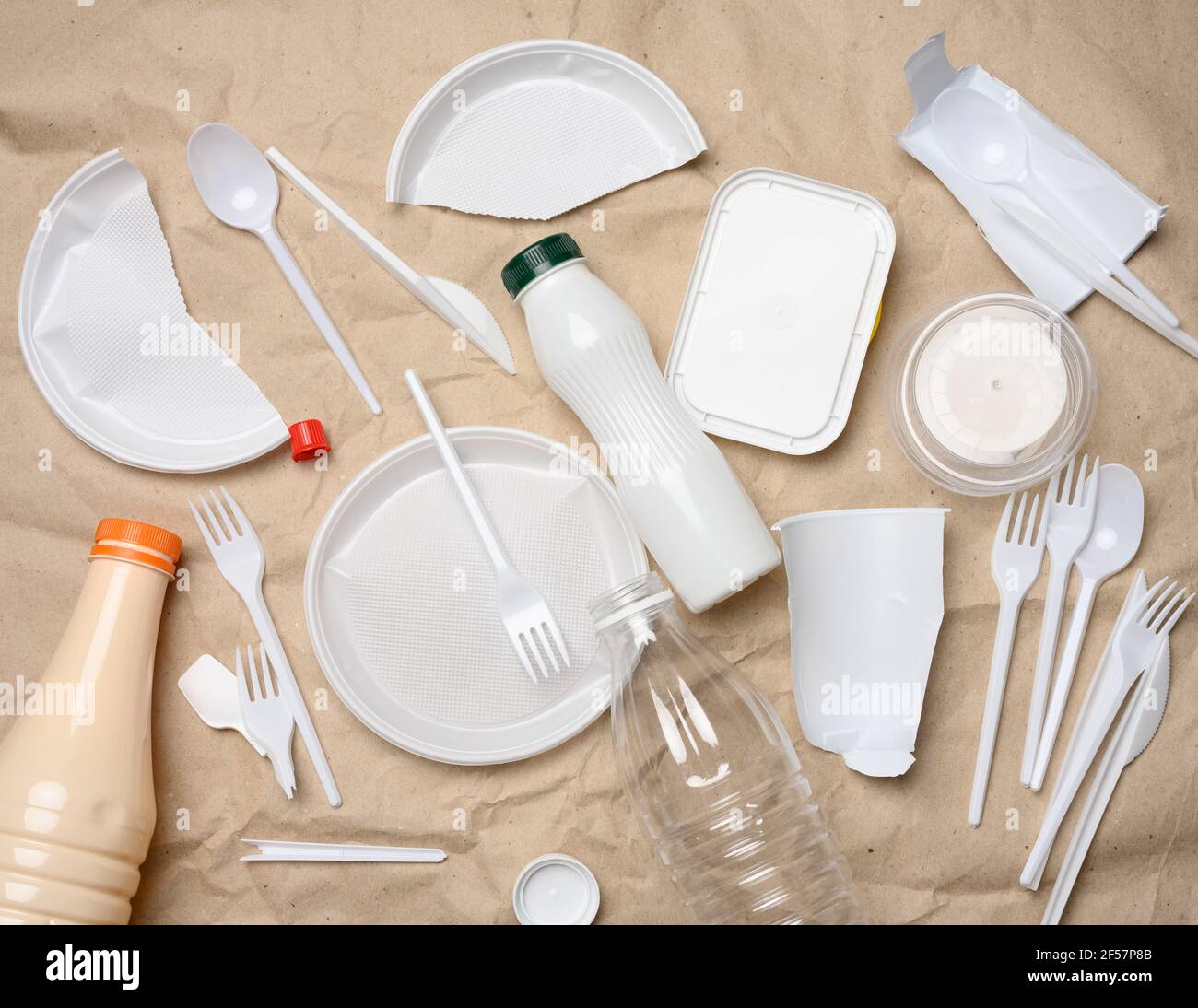 plastic waste from life on the background of brown kraft paper ...