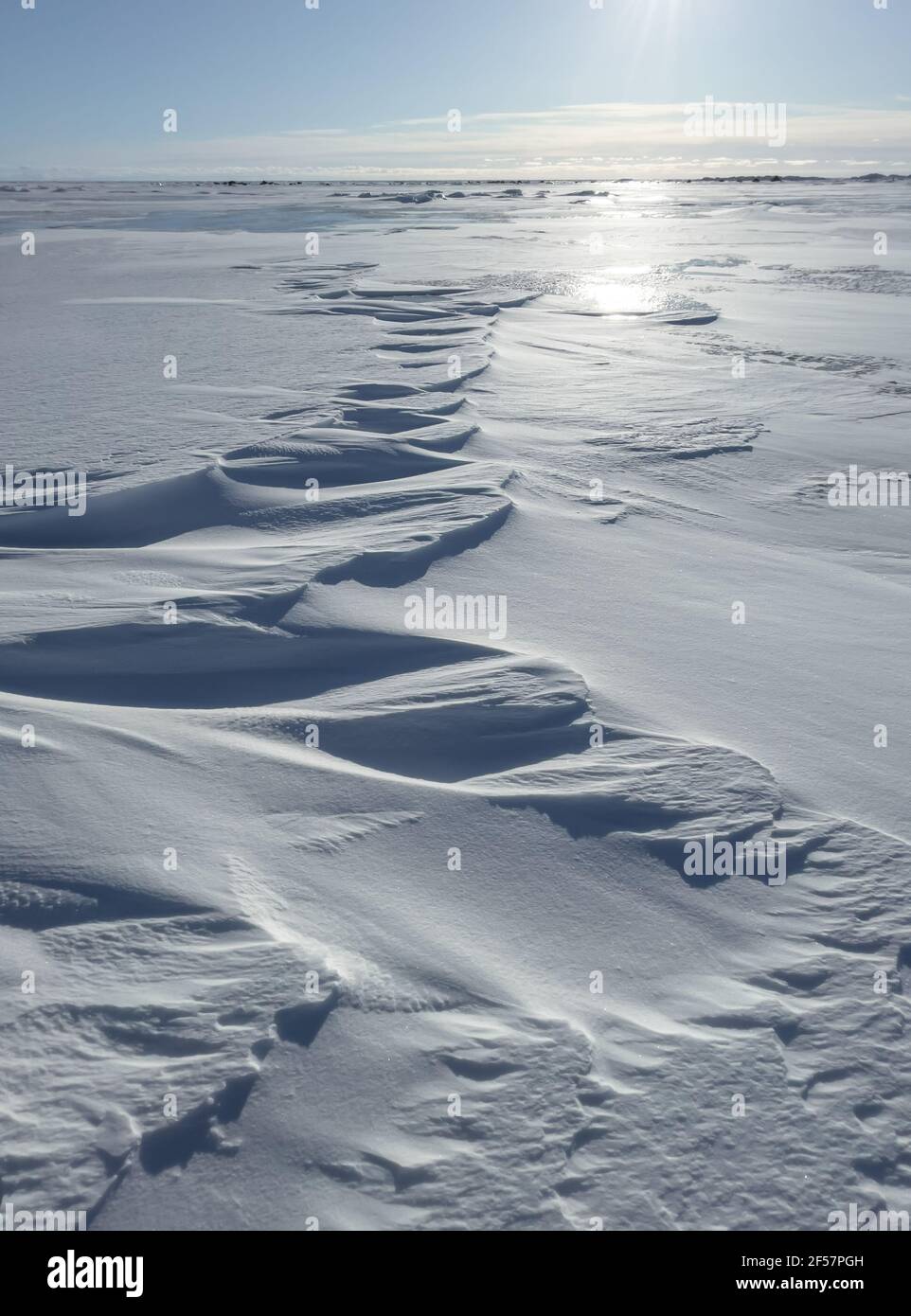 Ice slopes in sunny winter day, transparent ice of blue color, purely ...