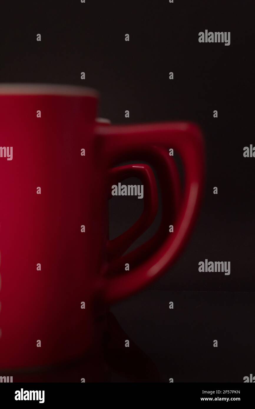Vertical shot of three red cups on the black background Stock Photo - Alamy
