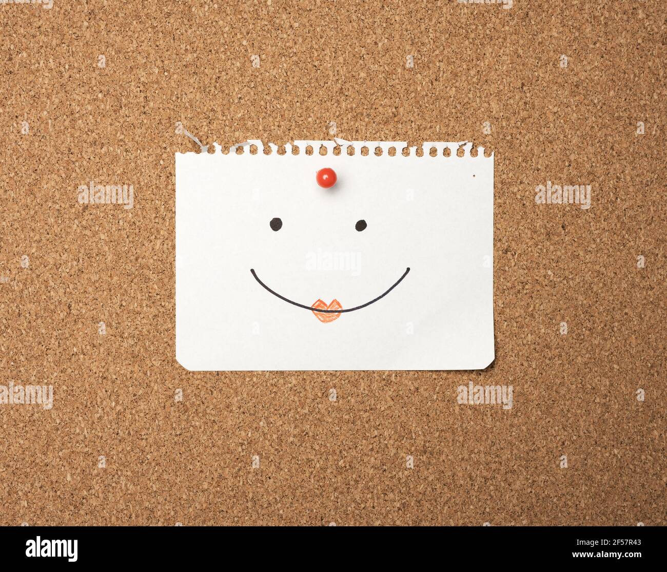 paper sheet with joyful emotion attached by button on brown board ...