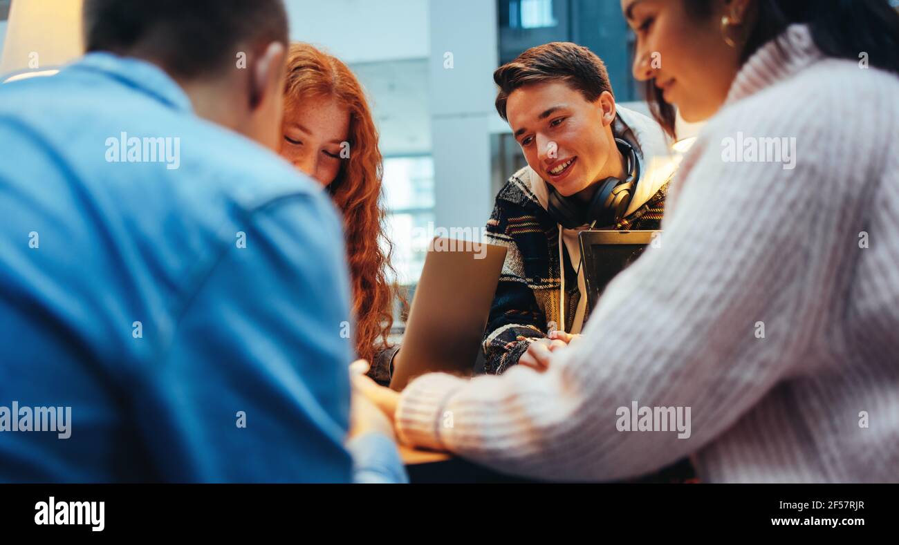 college students working on project in library. Friends doing group ...