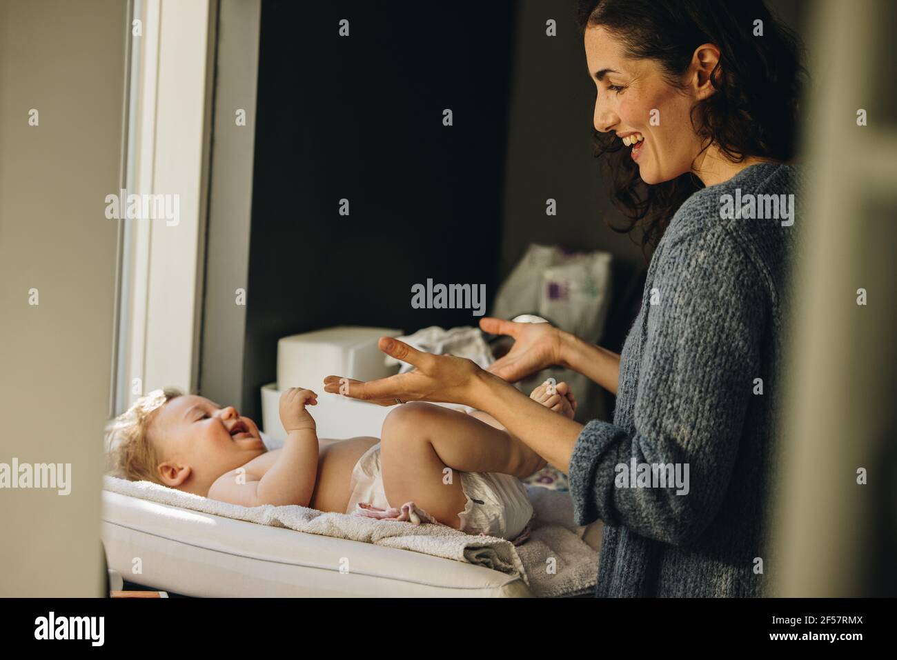 Baby mother change clothes diaper hi-res stock photography and images ...