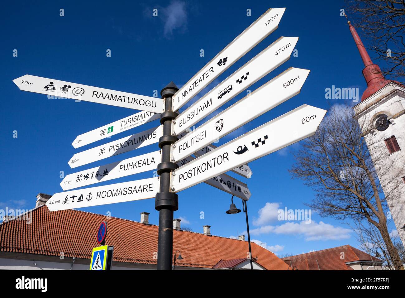 Direction sign is in center of town, between historical buildings ...