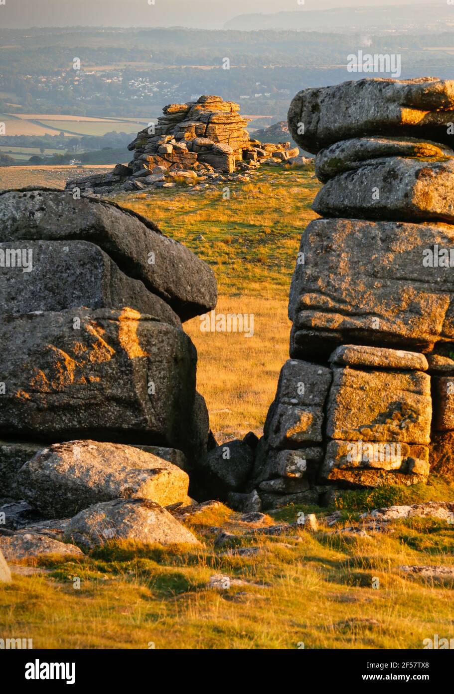 A distant tor peering through the rocky gap in the foreground at ...