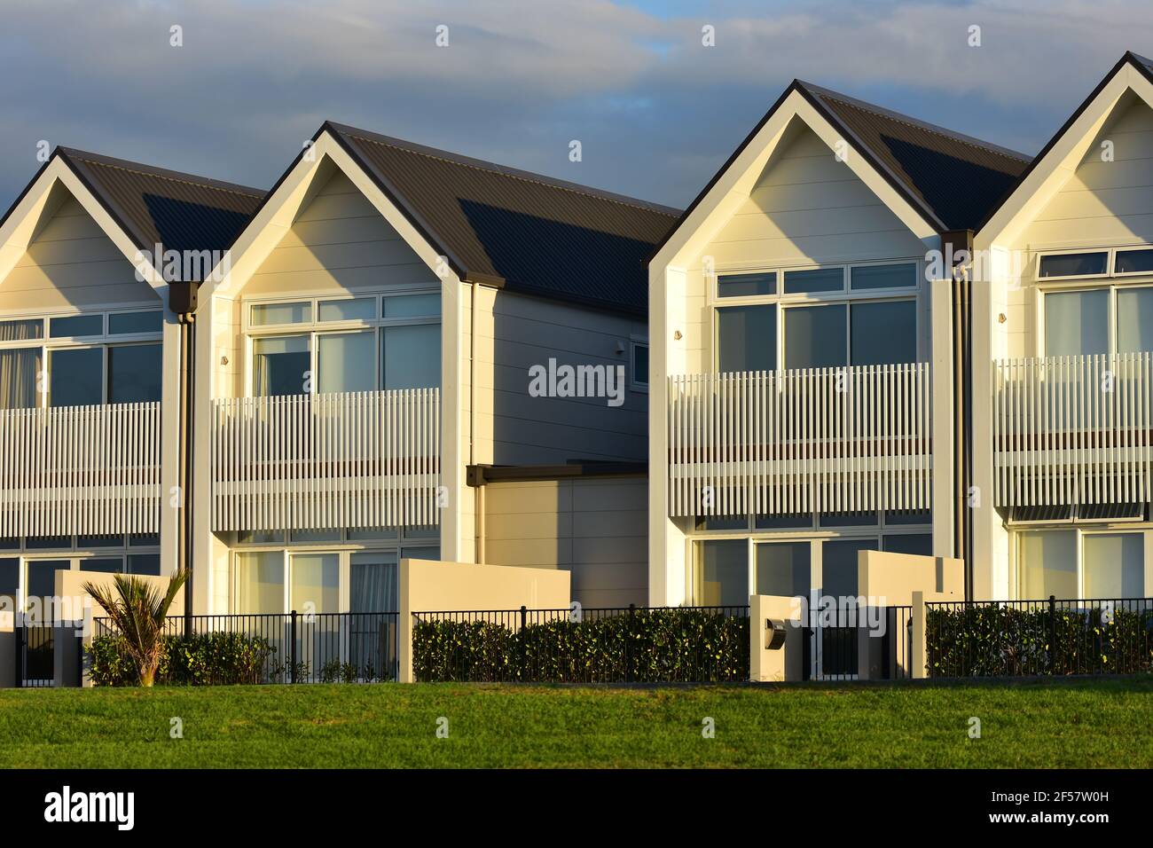 Modern townhouses with gable roofs without overhangs and small yards in ...