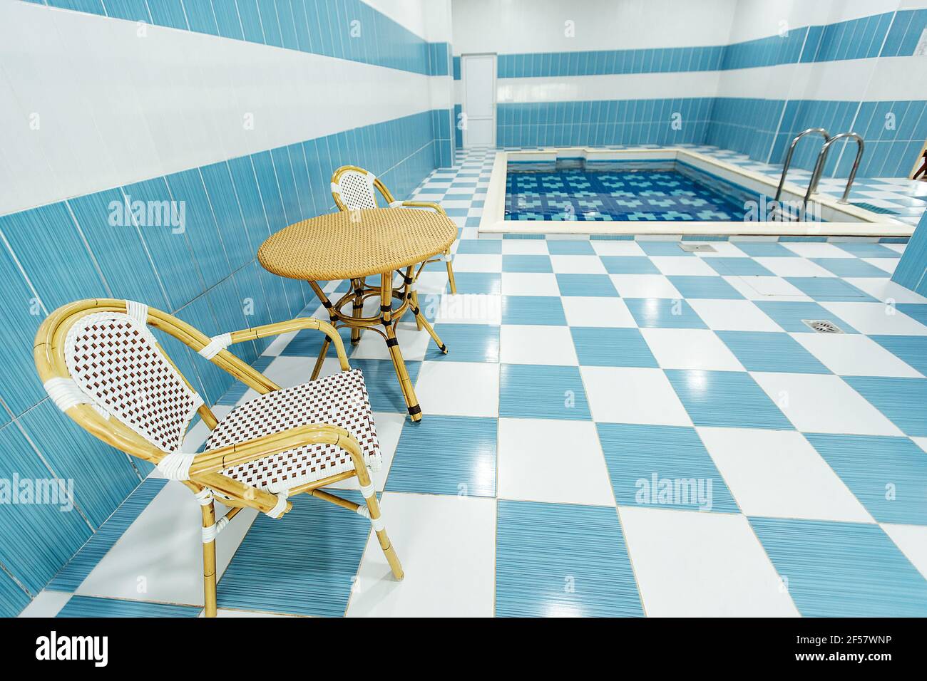 wooden chairs on the tiled floor. a seating area for guests near the ...