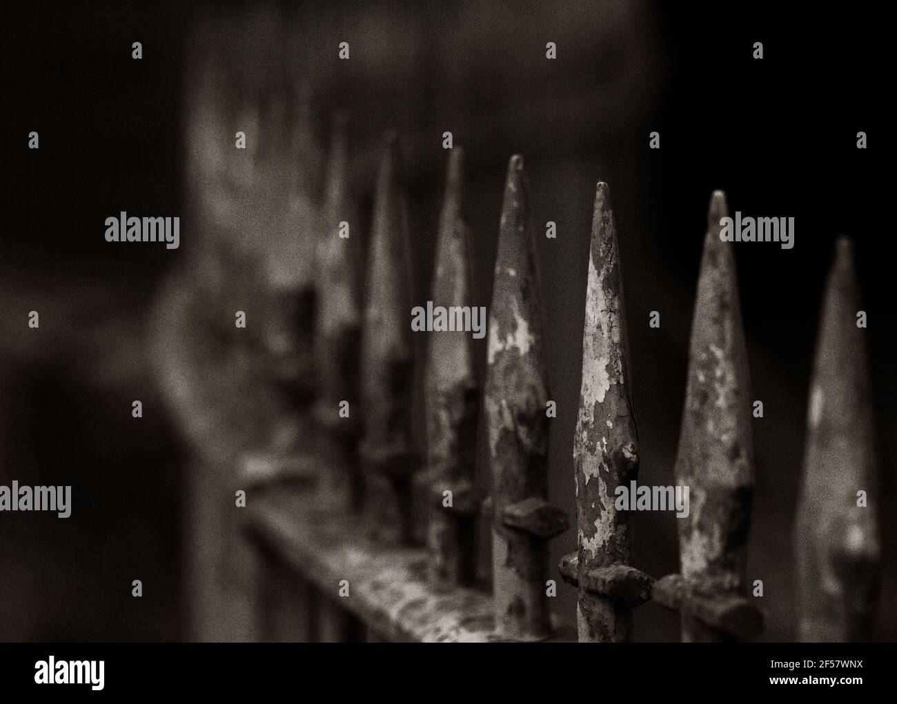 Wrought iron railing spikes flaking with paint and rust Stock Photo - Alamy