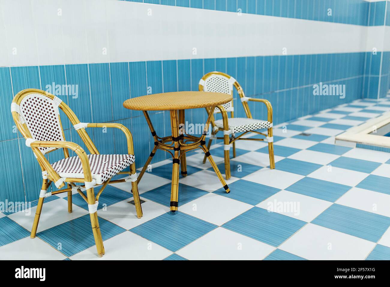 wooden chairs on the tiled floor. a seating area for guests near the ...