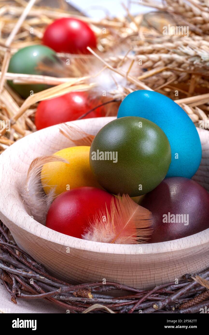 Eastern colorfully eggs in the nest along with wheat straws Stock Photo ...