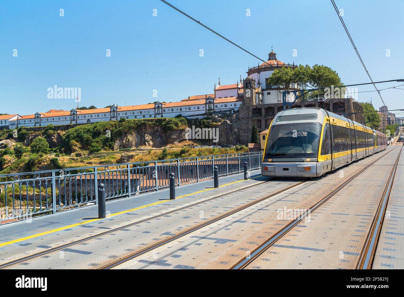 Modern metro train on the bridge in Porto in a beautiful summer day ...