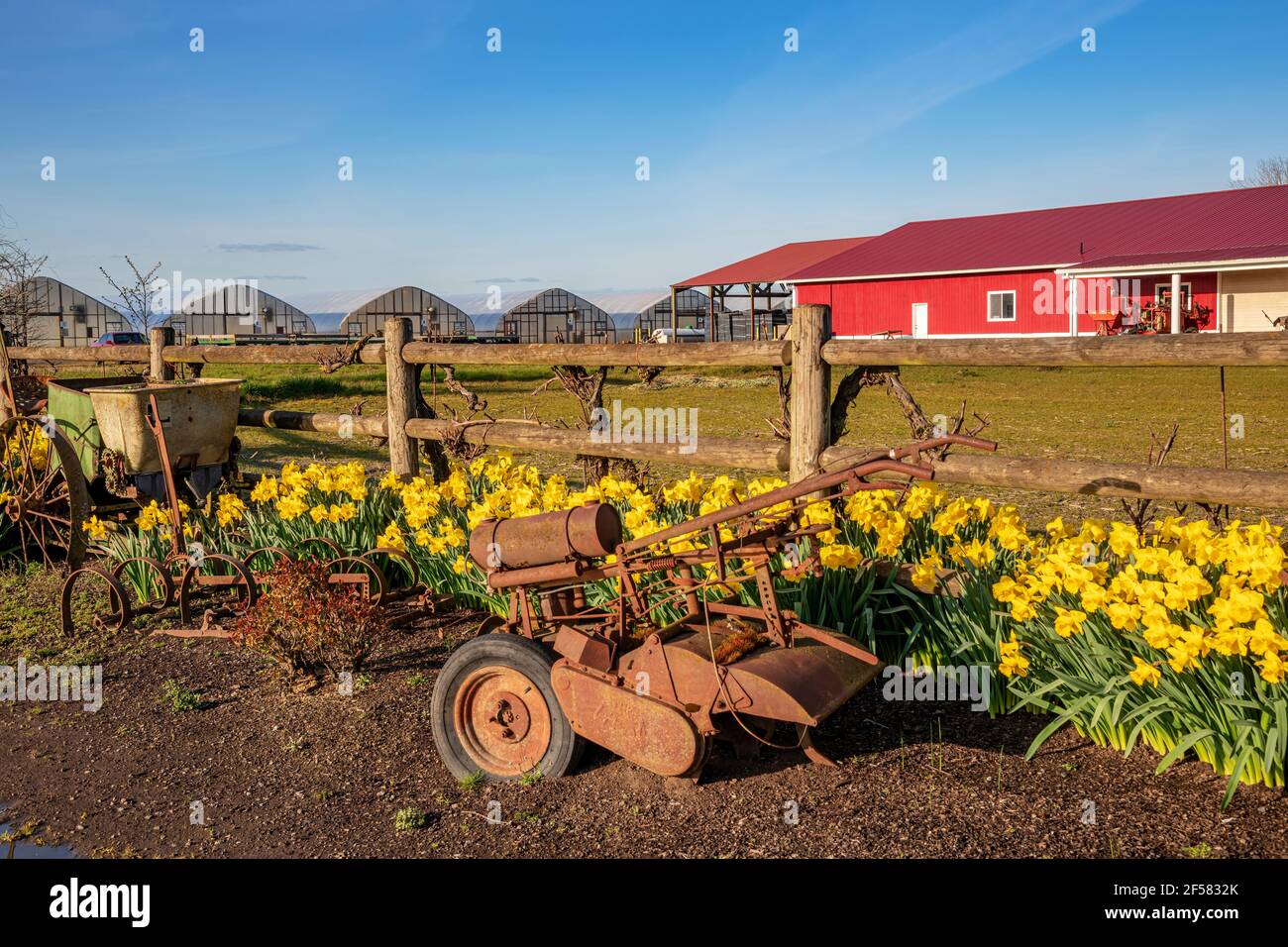 Old rusty farming equipment against a fence on a landscape Oregon state ...