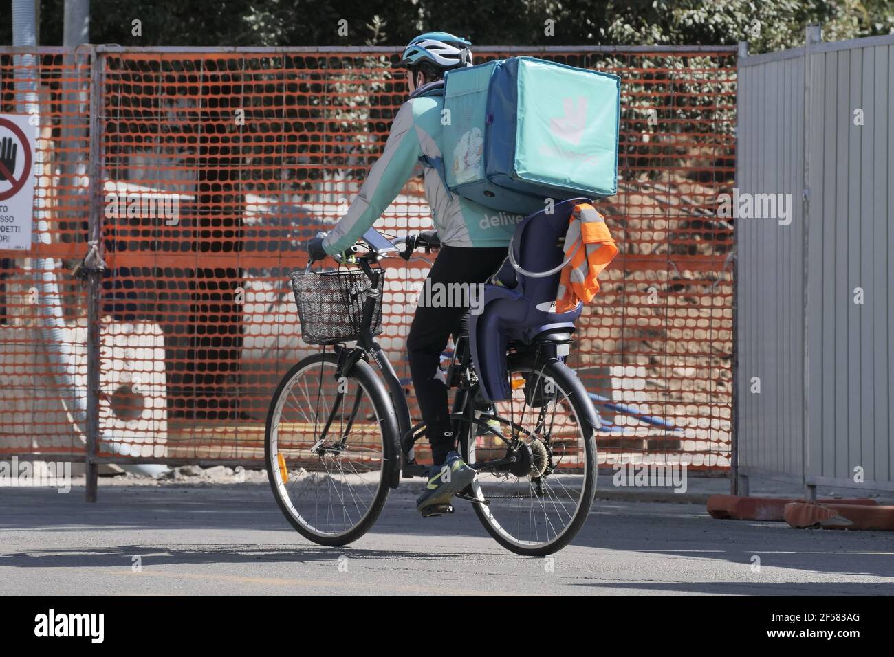 Bicycle food delivery rider working in the street in Bergamo during ...