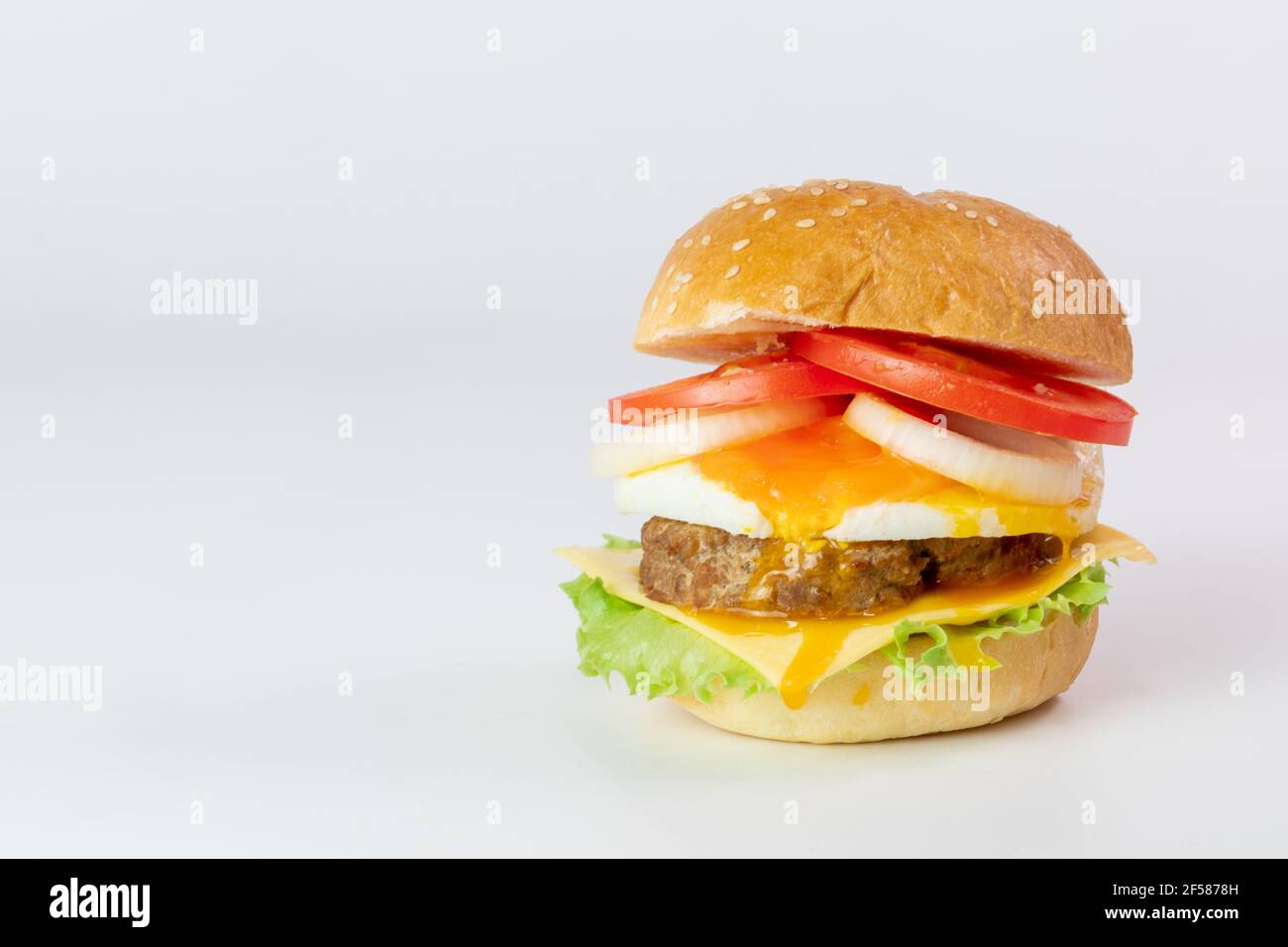 Burger, hamburger, cheeseburger, in bun with lettuce, tomato, onion ...
