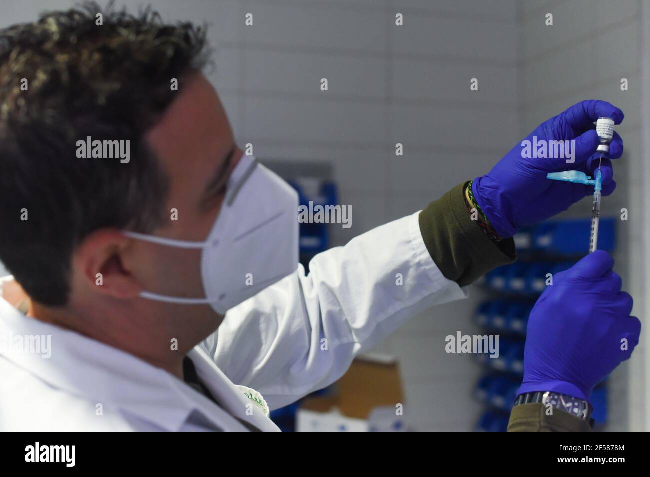 Coria City Hospital nurse, Raúl Martín, gets the syringes with the dose ...