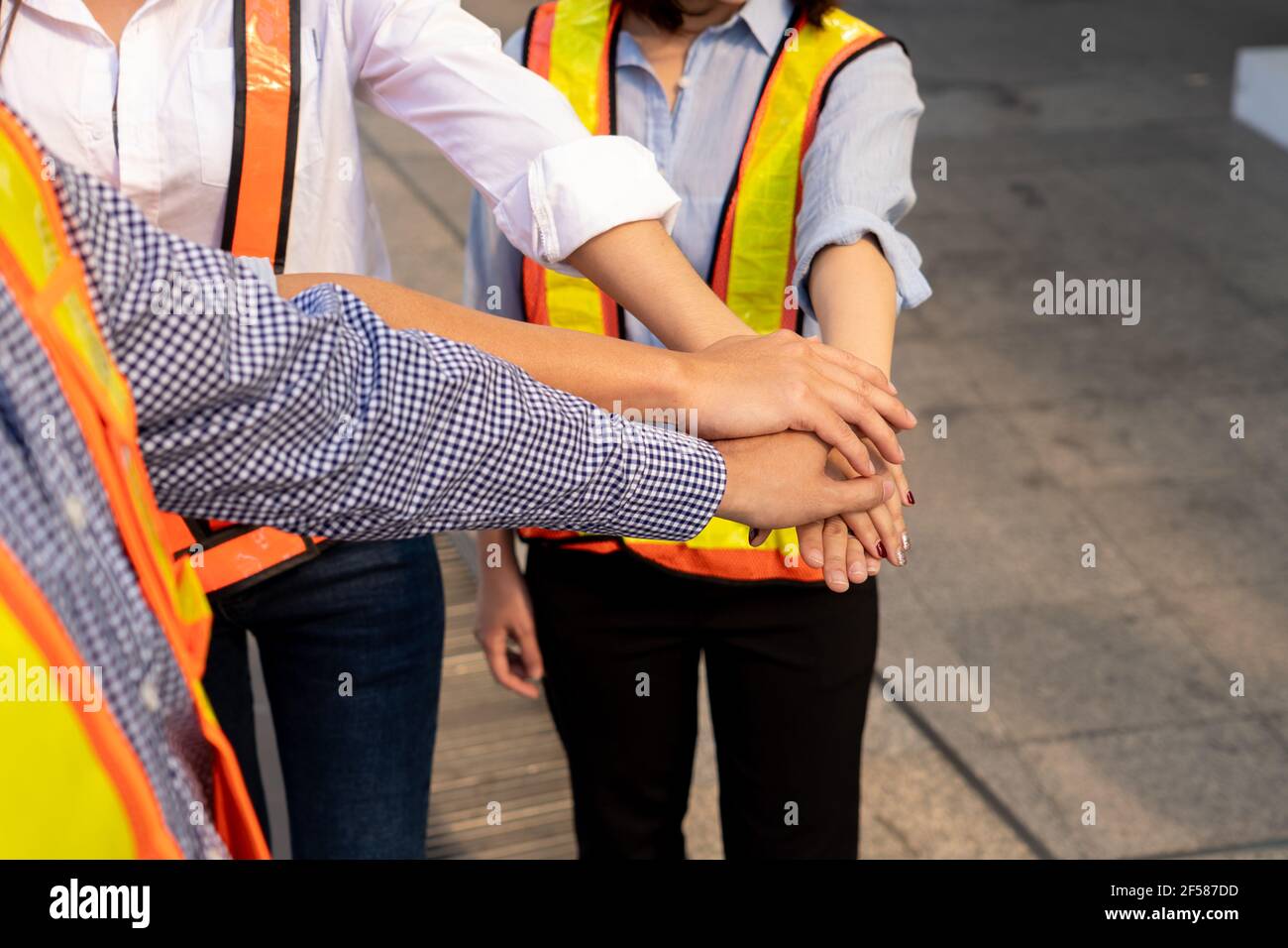 Businessmen and engineers join hands, Teamwork of the construction to ...