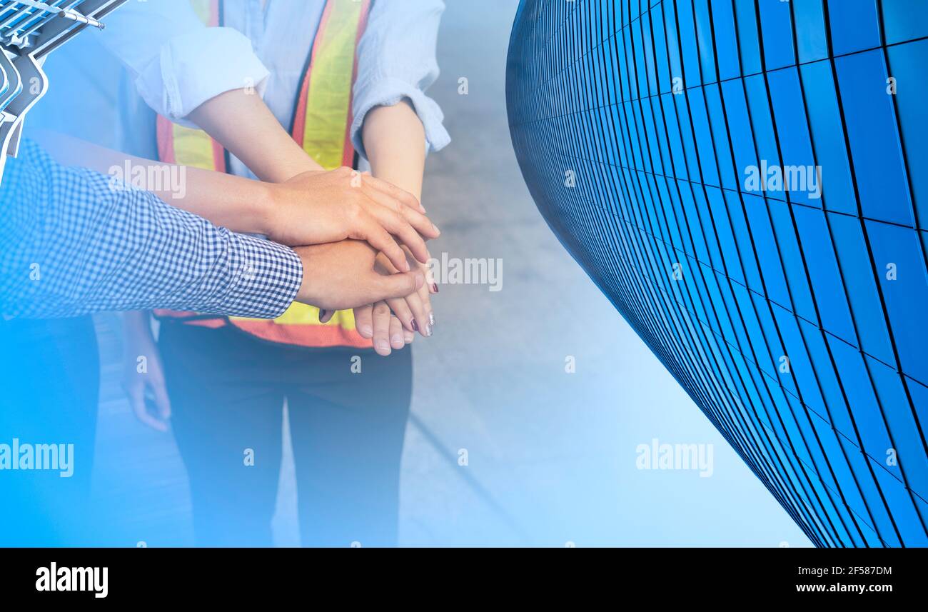 Businessmen and engineers join hands, Teamwork of the construction to ... Businessmen and engineers join hands, Teamwork of the construction to ...