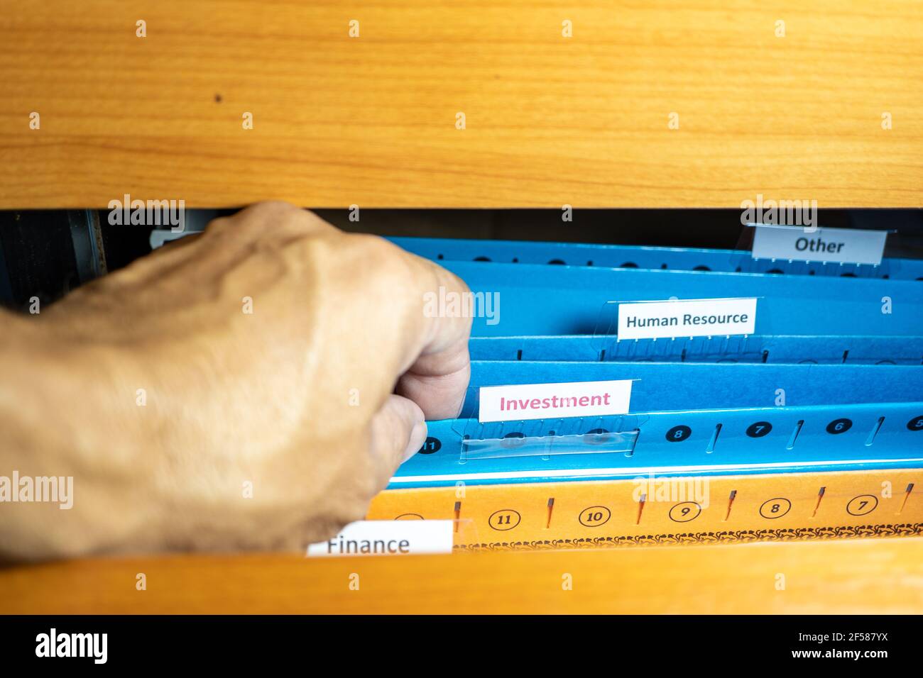 Investment Documents, red lettering in the file folder in wooden file ...