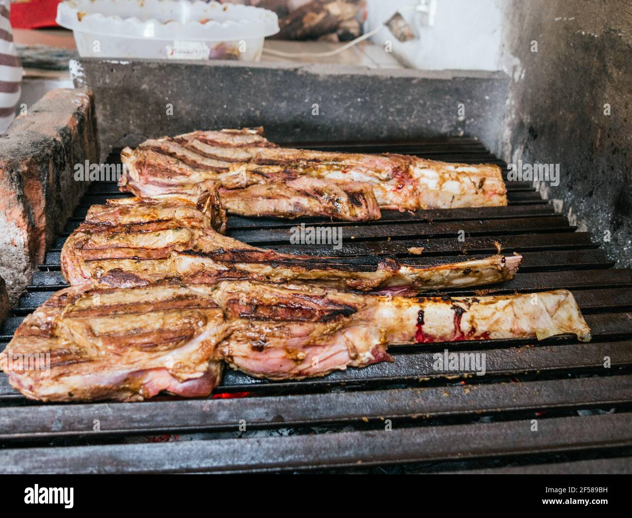 Tomahawk rib beef steak on hot black grill with flames Stock Photo - Alamy
