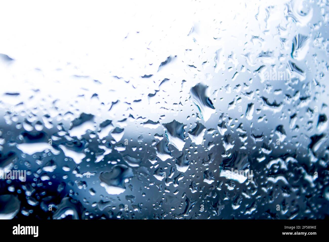 Raindrops on the window. Glass fogging and evaporation. Rain outside ...