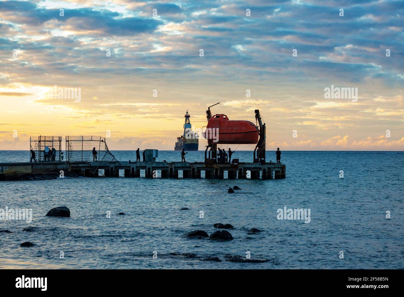 fishing from jetty at Pointe aux Sable, west coast of Mauritius Stock ...