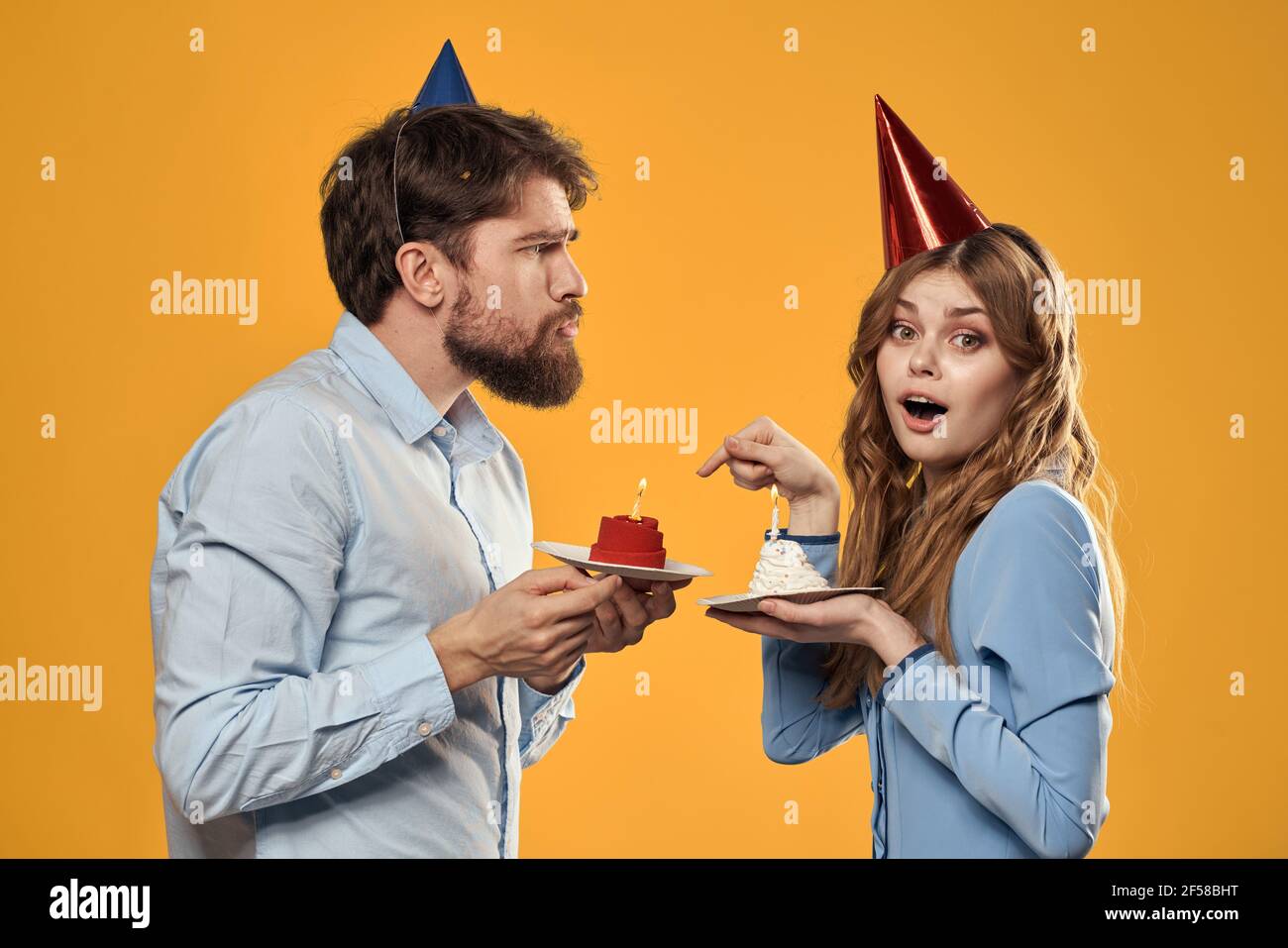 Birthday party man and woman fun yellow background cap holiday Stock ...